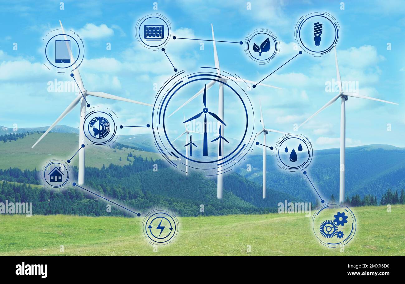 Alternative energy source. Wind turbines in field under blue sky and ...