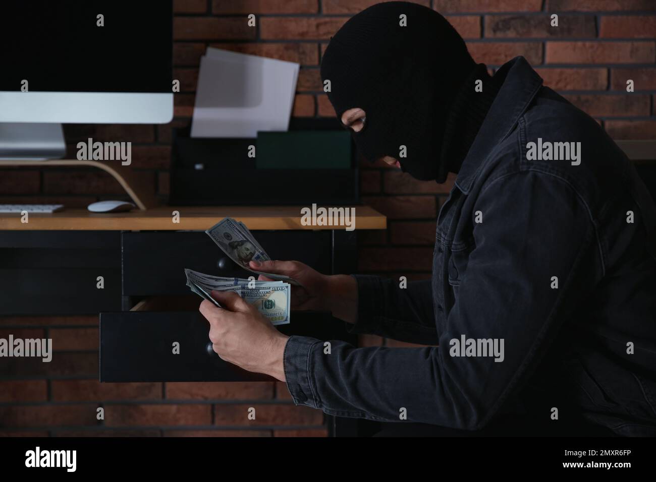 Dangerous masked criminal stealing money from house Stock Photo - Alamy
