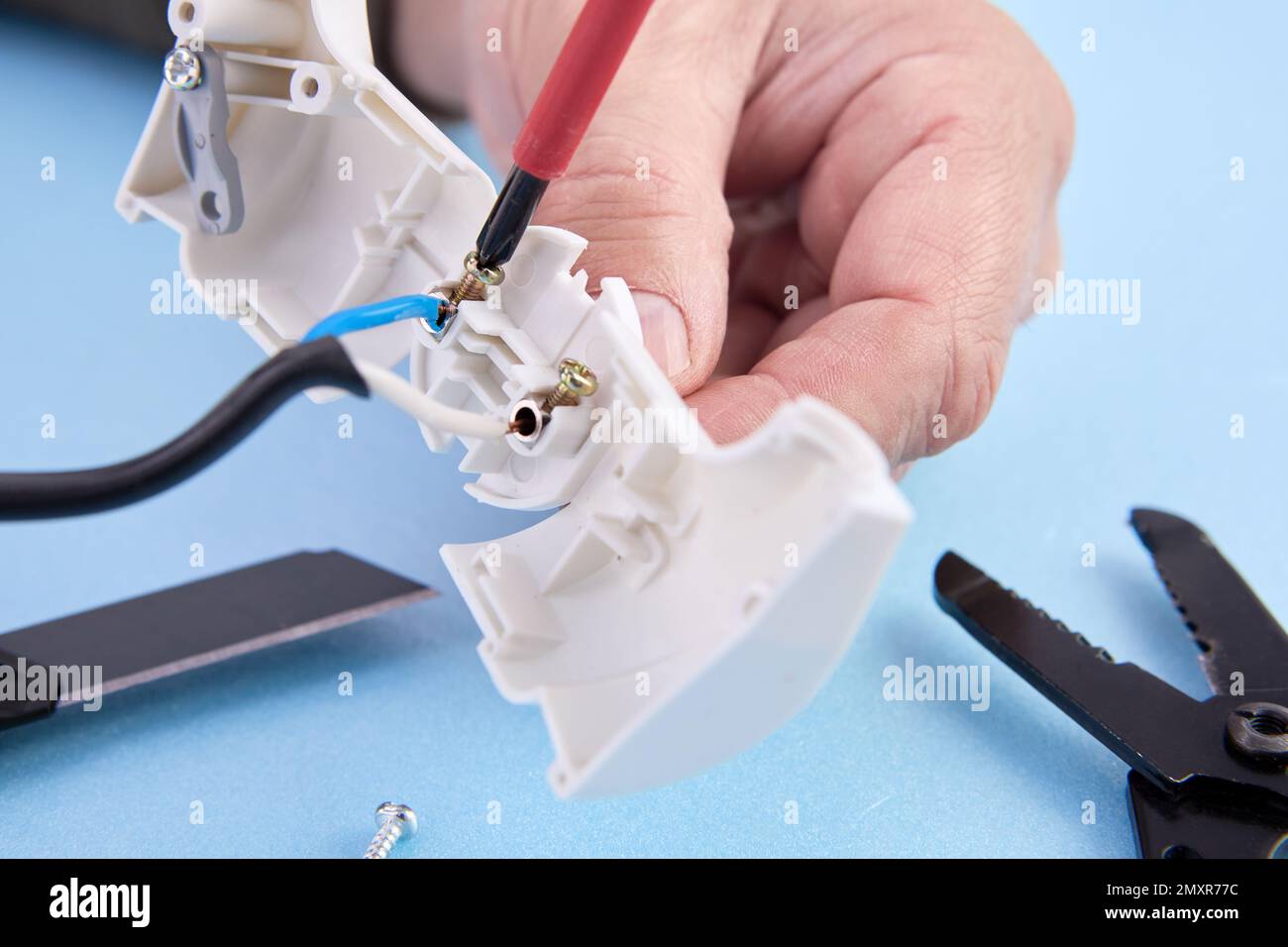 Connecting electrical wire to collapsible electric plug, electrician ...