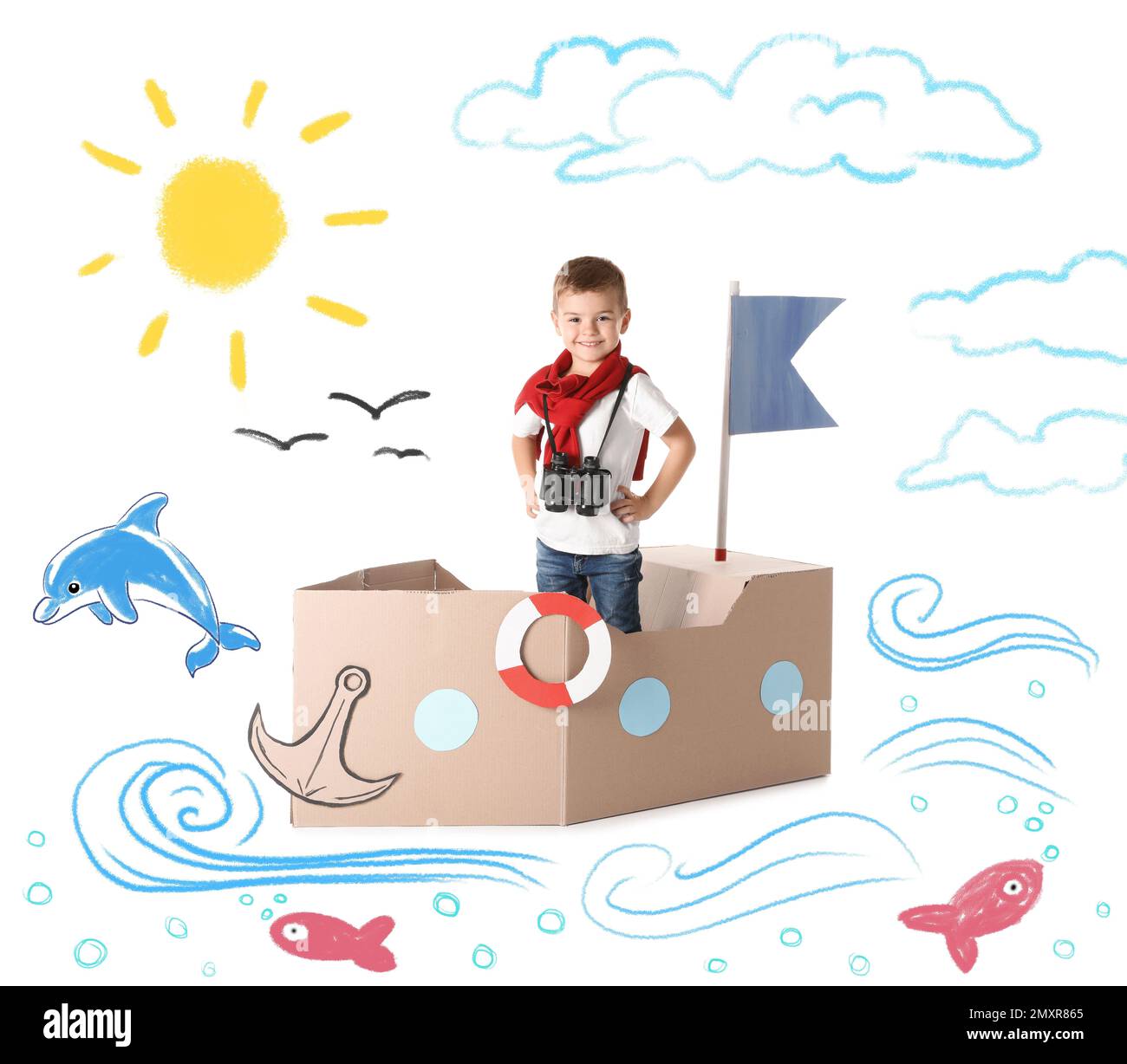 Cute little boy playing in cardboard ship on white background with ...