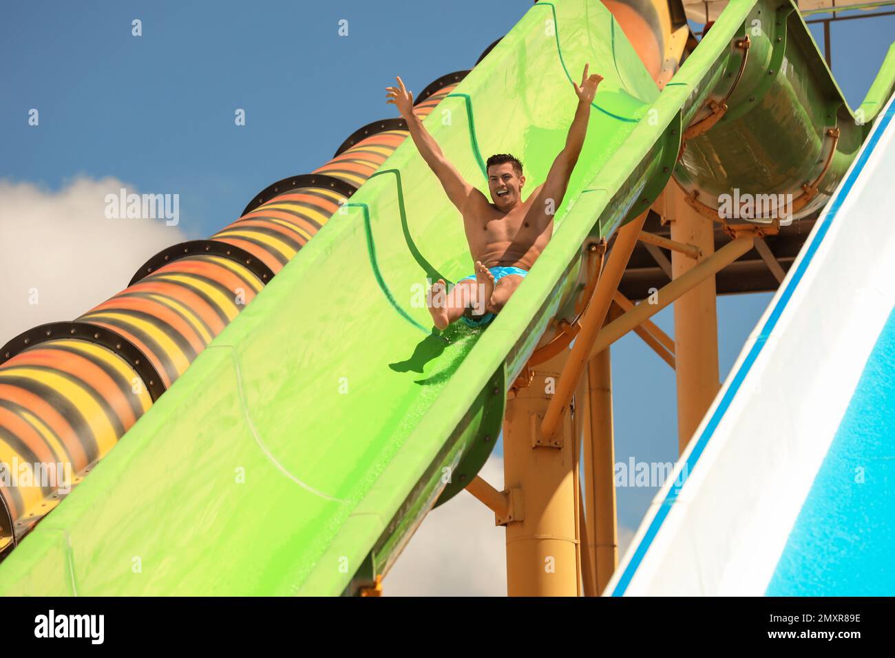 Man on slide at water park. Summer vacation Stock Photo - Alamy