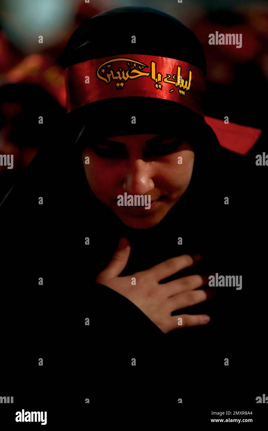 A Lebanese Shiite Muslim supporter of Hezbollah wears a headband with ...