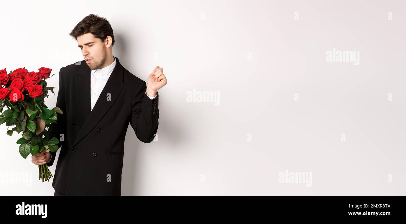 Image of elegant and sassy man in black suit, looking confident and ...