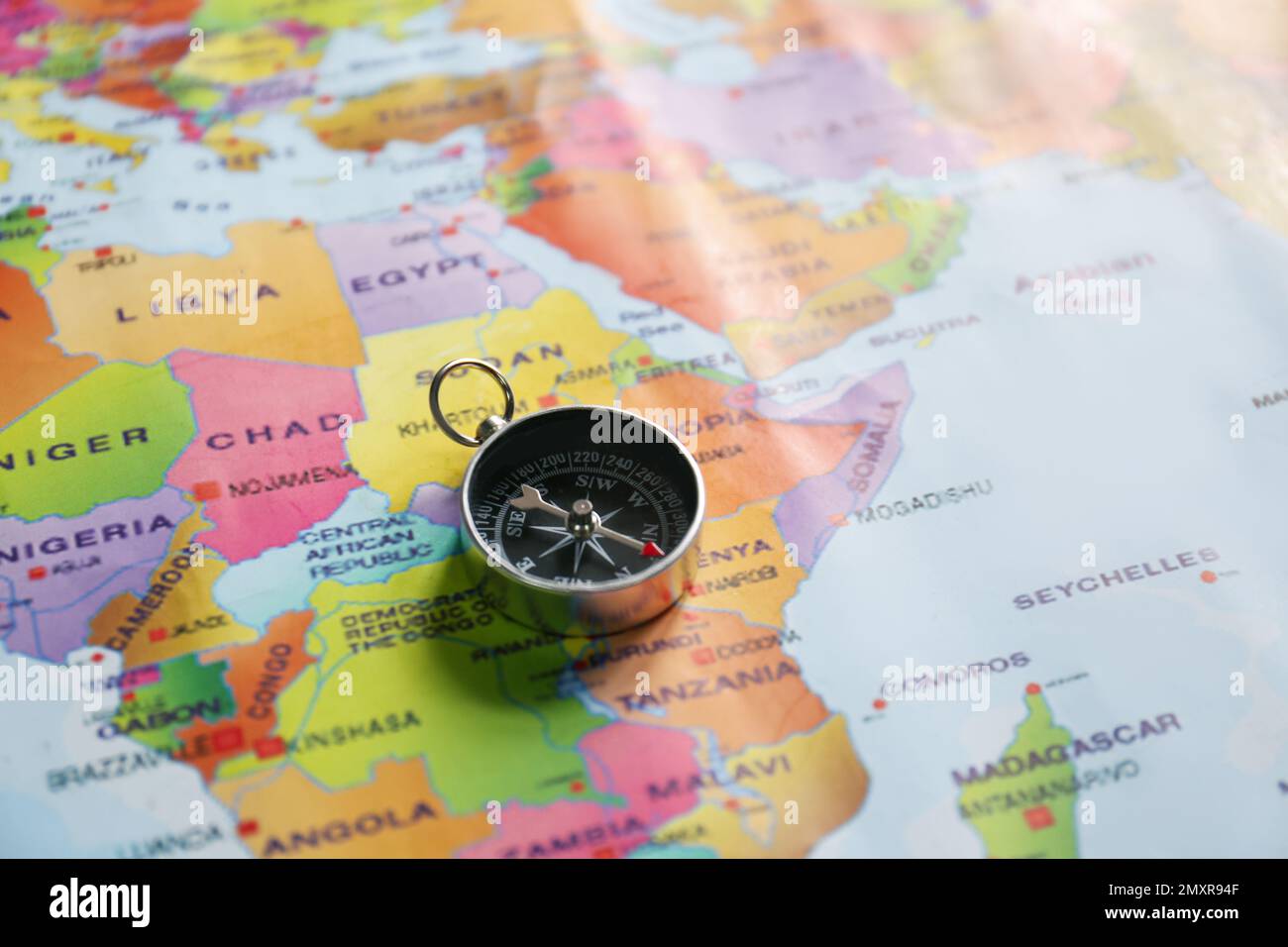 Modern compass on world map, closeup. Trip planning Stock Photo - Alamy