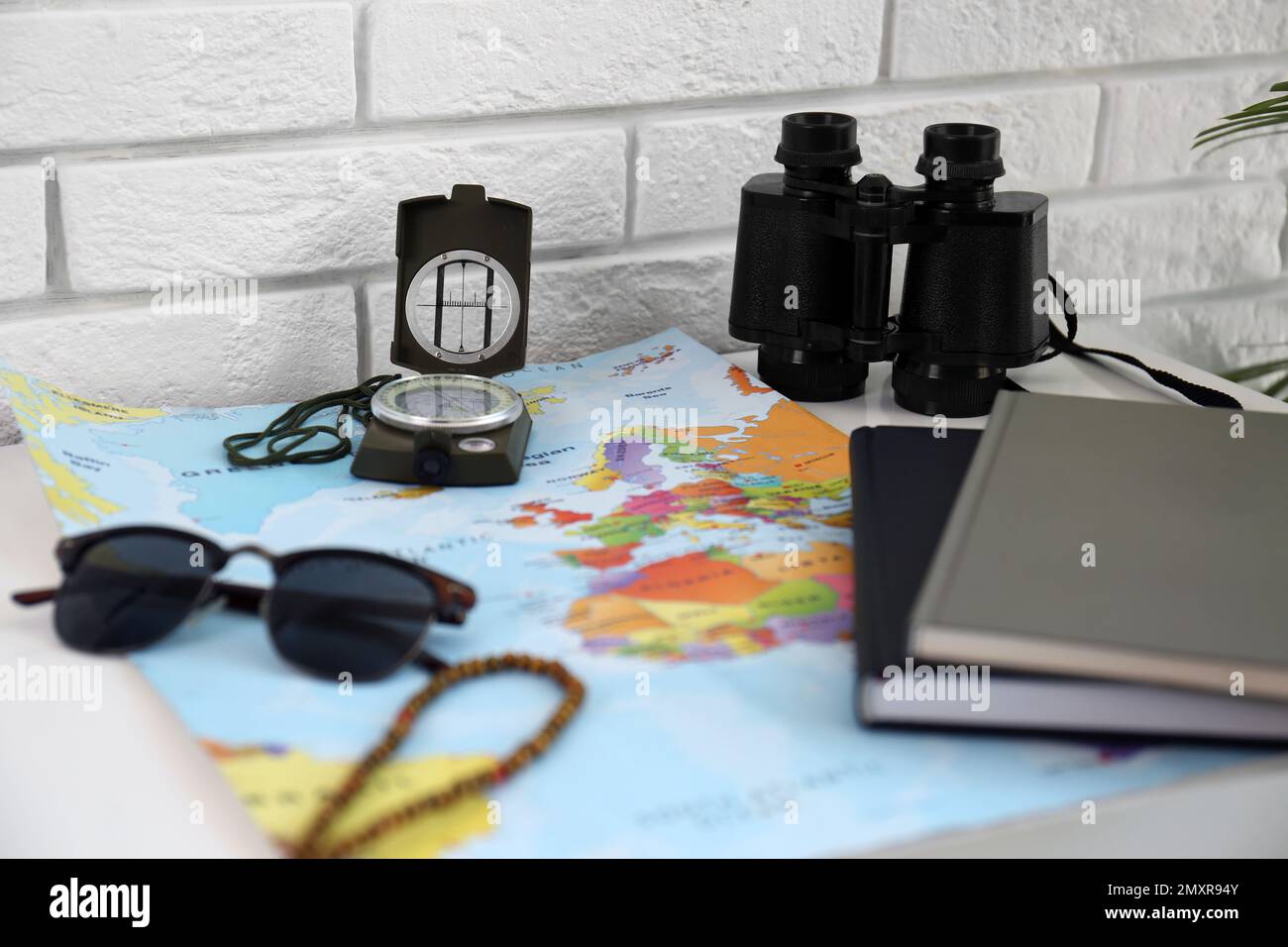Composition with world map and different items on table. Trip planning ...