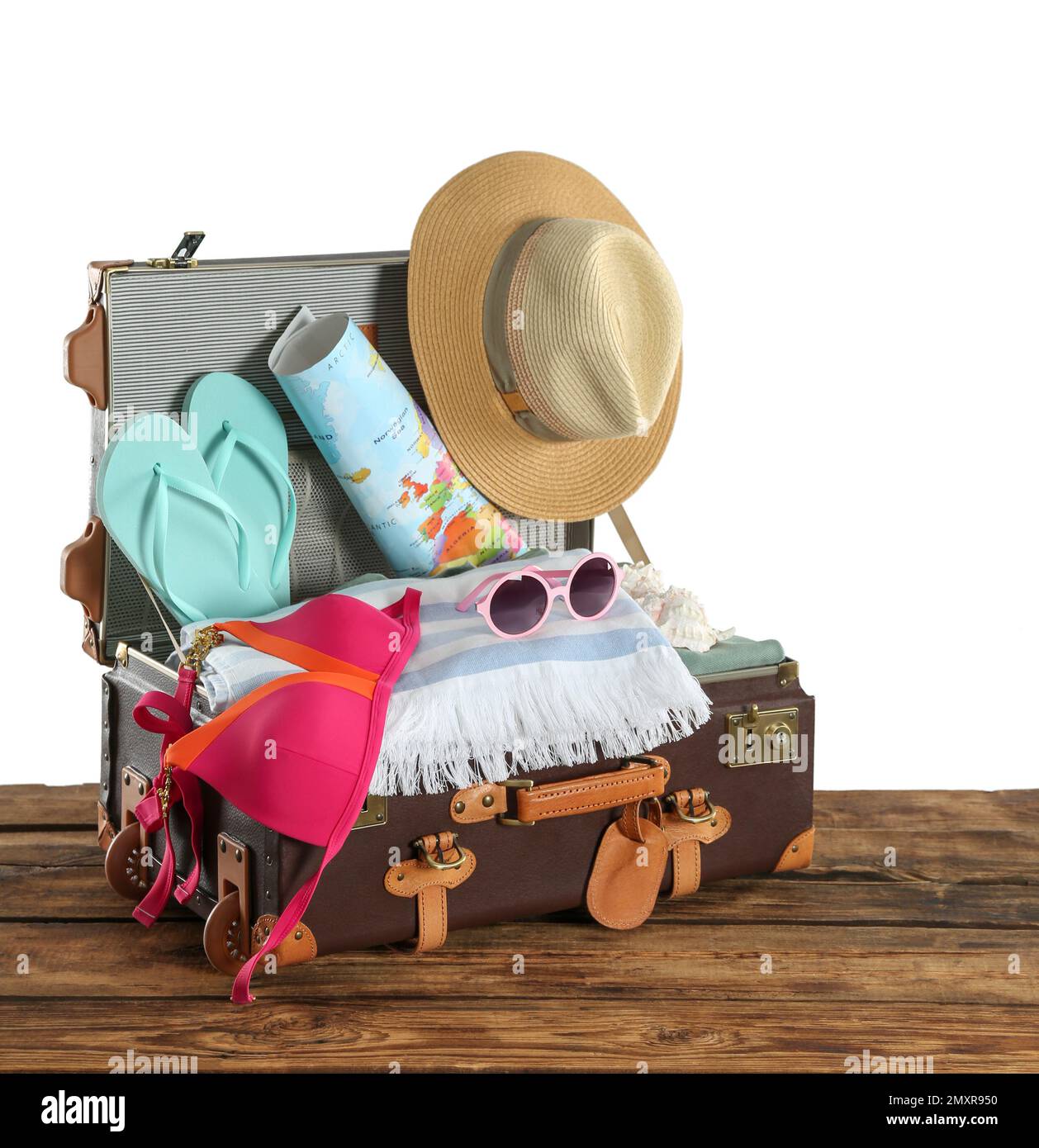 Open vintage suitcase with different beach objects packed for summer ...
