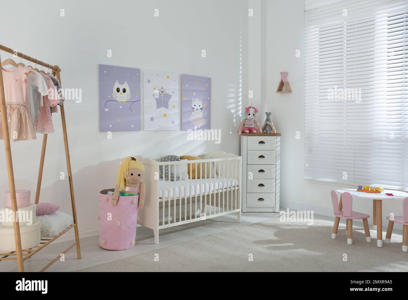 Baby room interior with cute posters, crib and clothing rack Stock ...