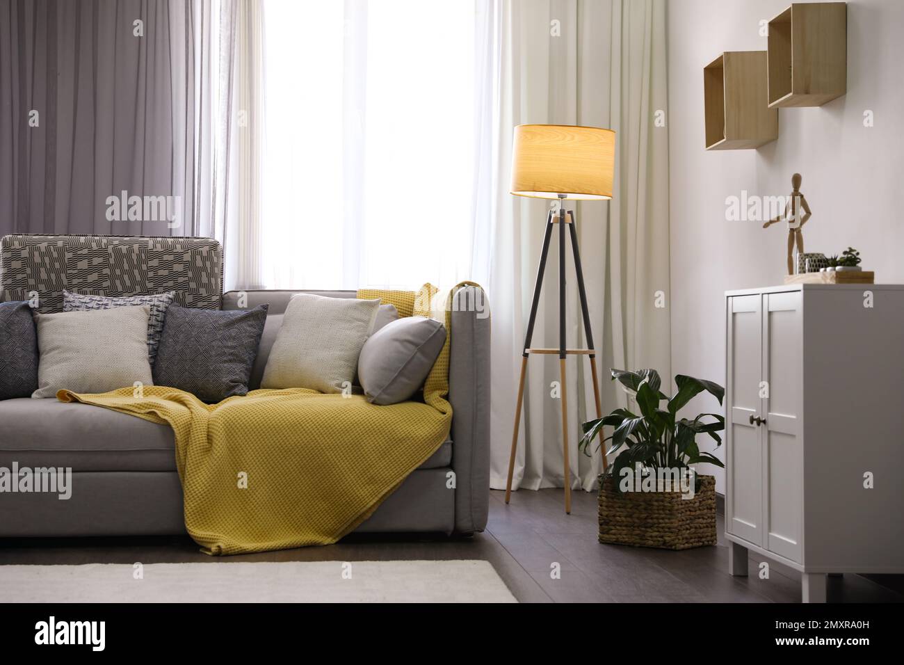 Elegant living room with comfortable sofa near window. Interior design ...