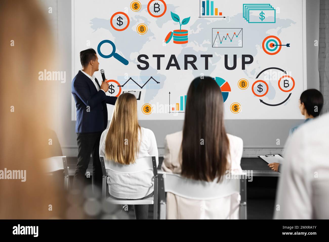 Business trainer giving lecture in conference room with projection ...