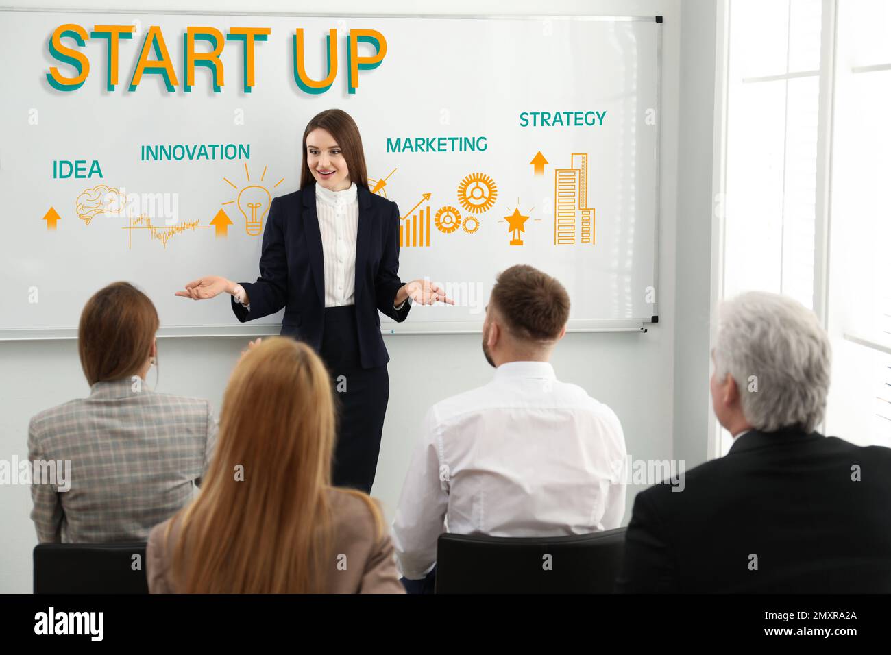 Business trainer giving lecture in conference room Stock Photo - Alamy