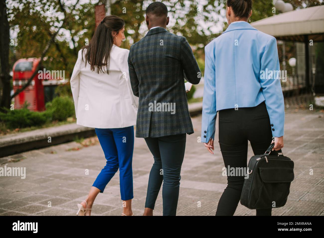 Three business colleagues walking Stock Photo - Alamy