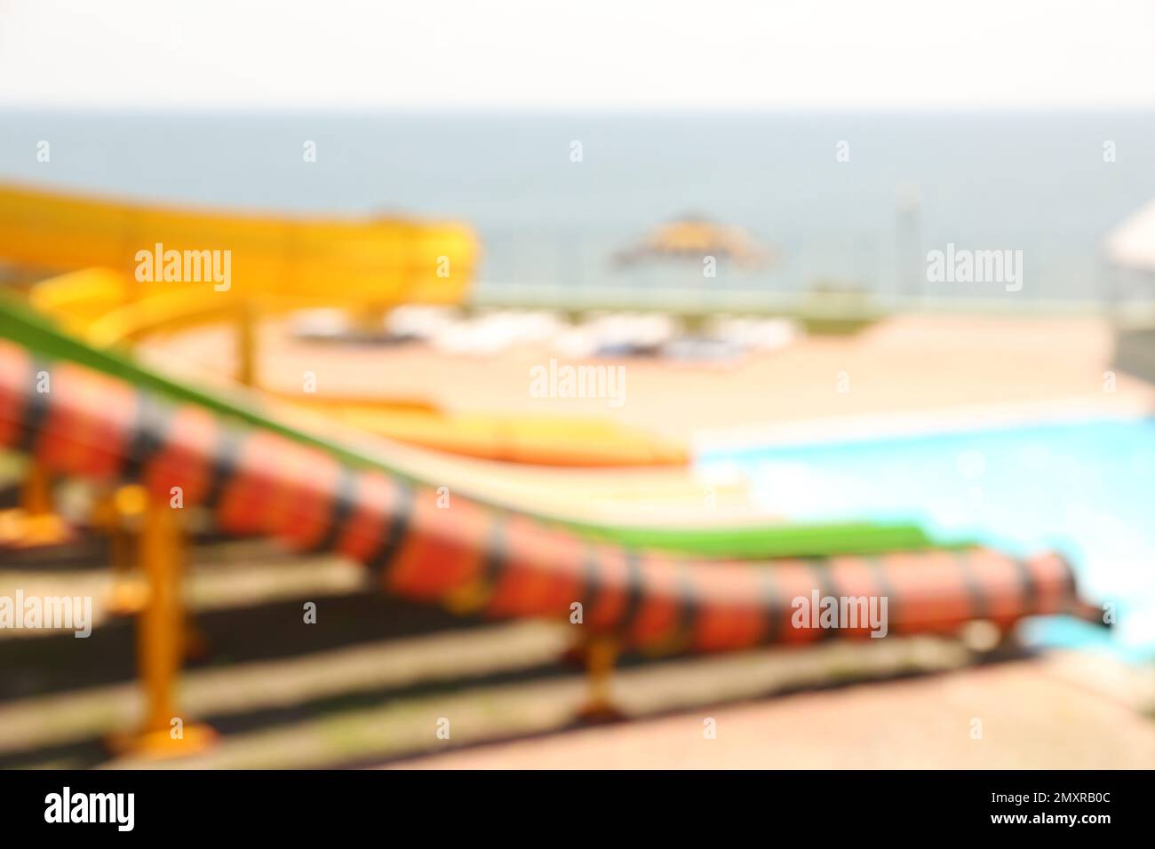 Different colorful slides in water park, blurred view Stock Photo - Alamy
