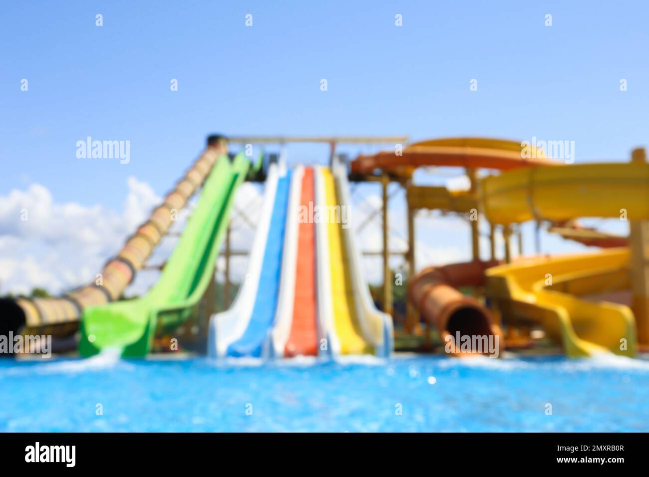 Different colorful slides in water park, blurred view Stock Photo - Alamy