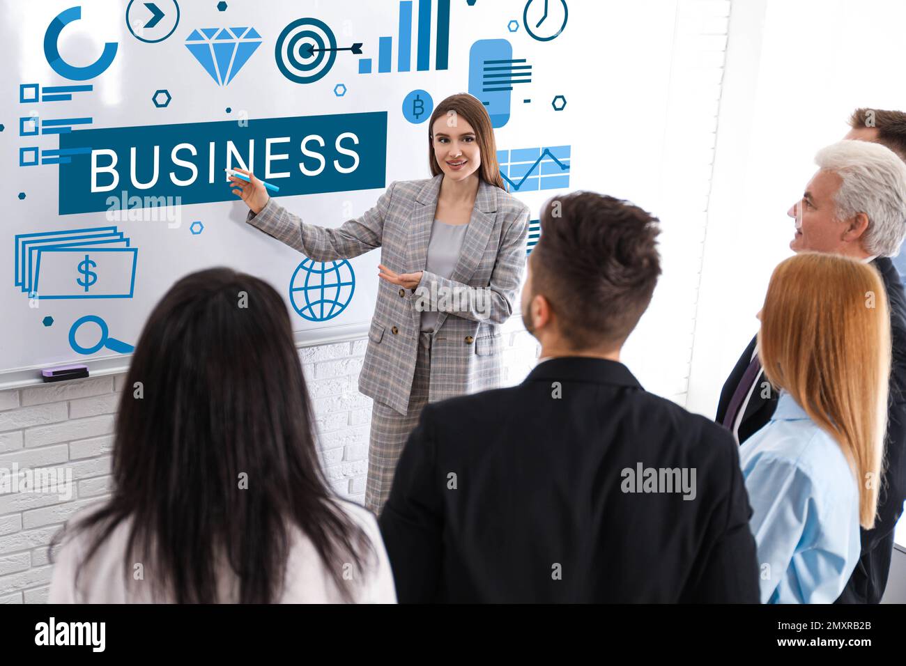 Business trainer giving lecture in conference room Stock Photo - Alamy