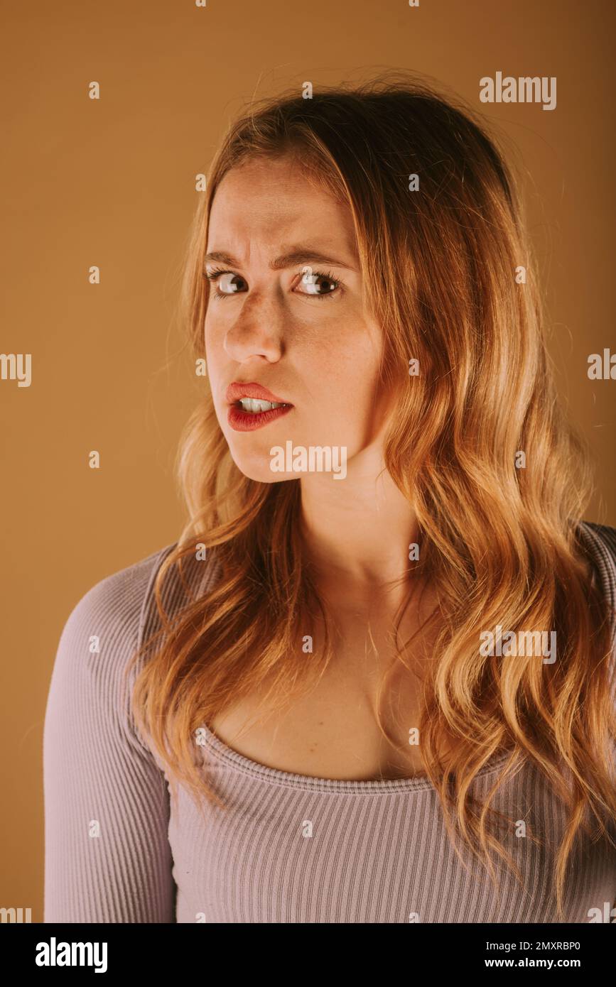 Beautiful girl making a mad face while posing at the studio Stock Photo ...