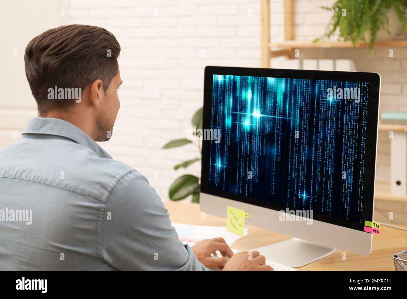 Professional programmer working with computer in office Stock Photo - Alamy