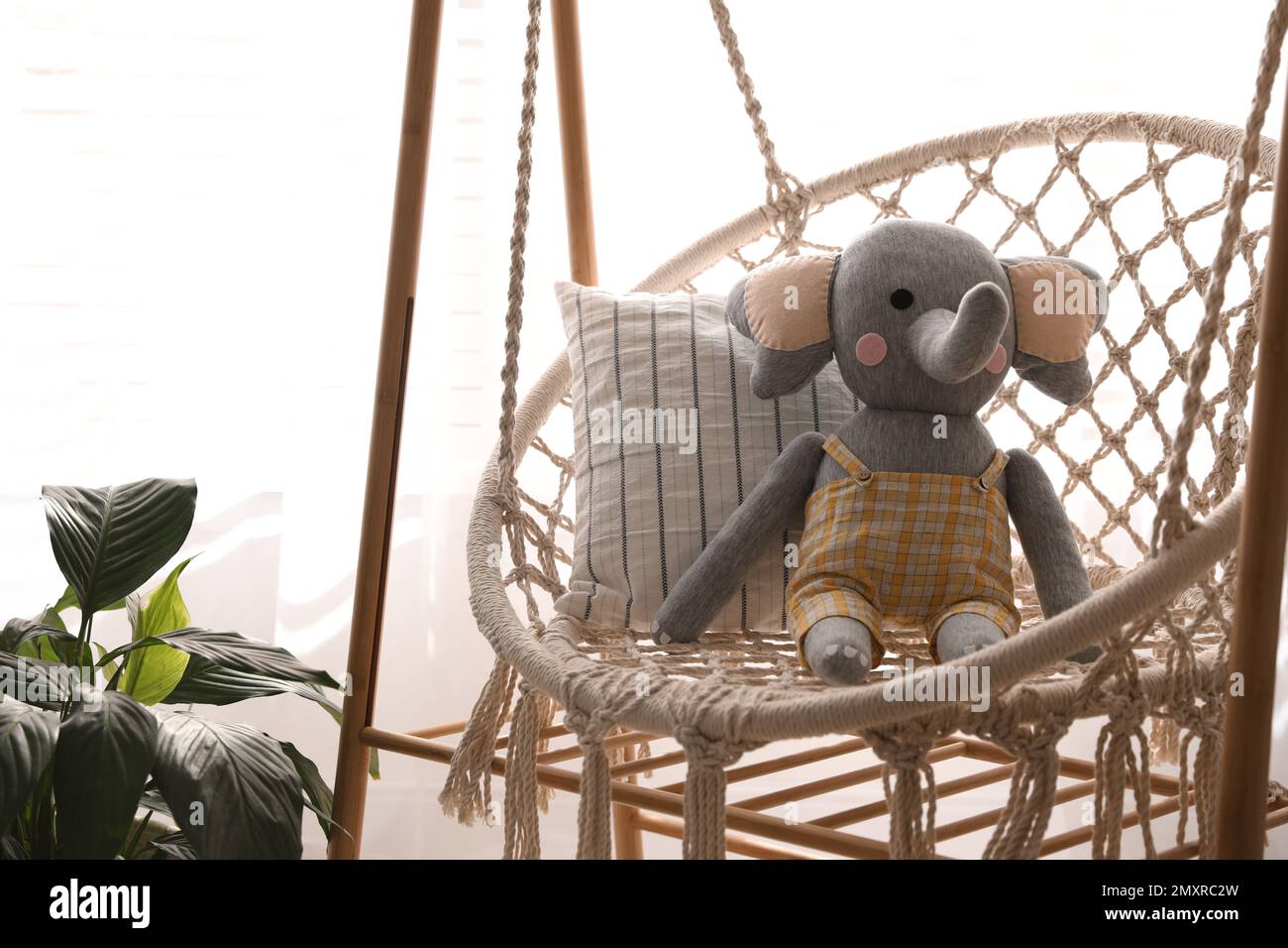 Wooden swing with toy elephant indoors. Interior design Stock Photo - Alamy