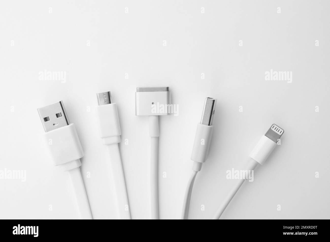 Charge cables on white background, top view. Modern technology Stock ...
