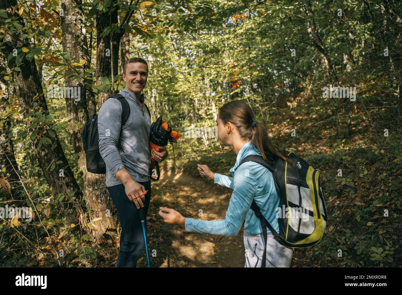 Lovely hikers coming down a mountain. They are having fun Stock Photo ...