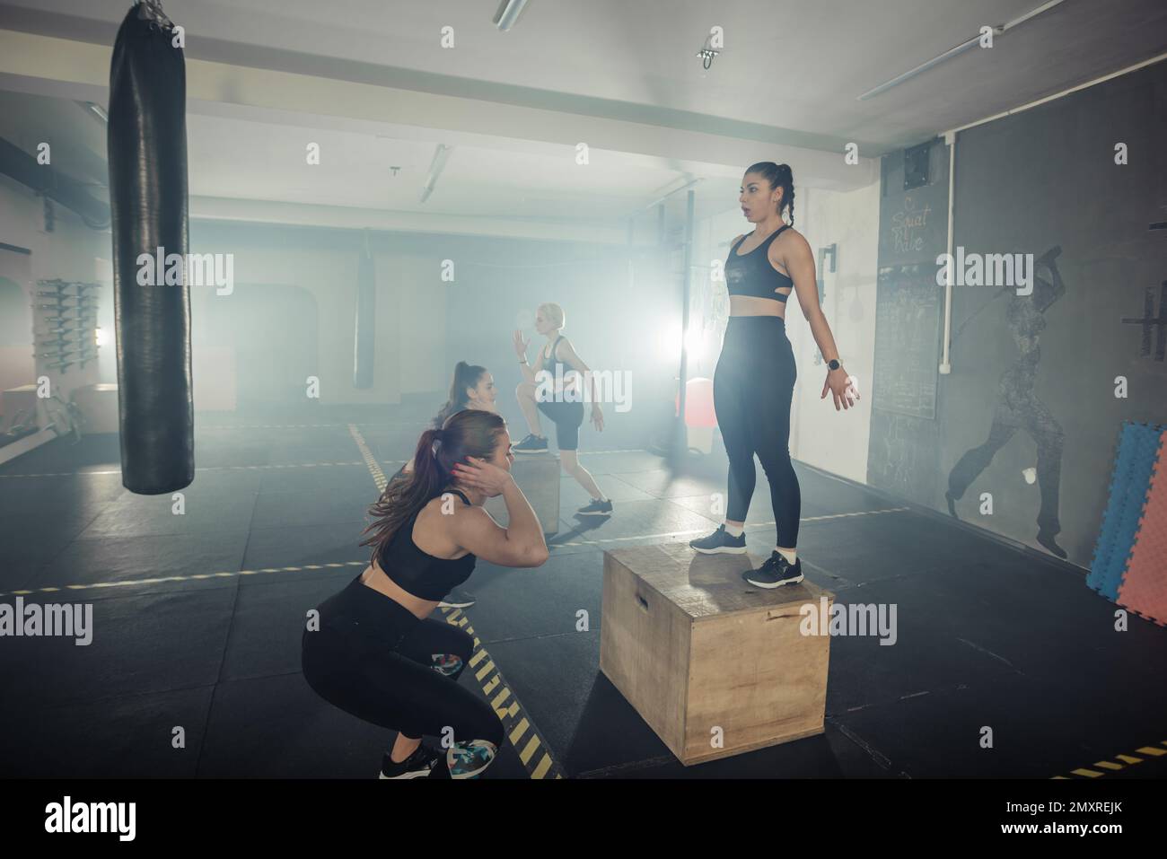 A female group having functional fitness training doing standing ...