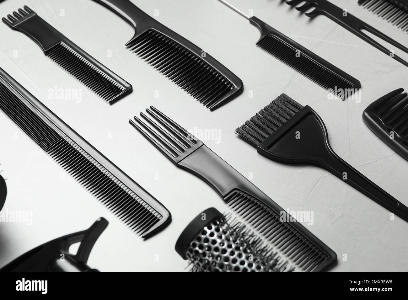 Different combs on light grey stone background, closeup Stock Photo - Alamy