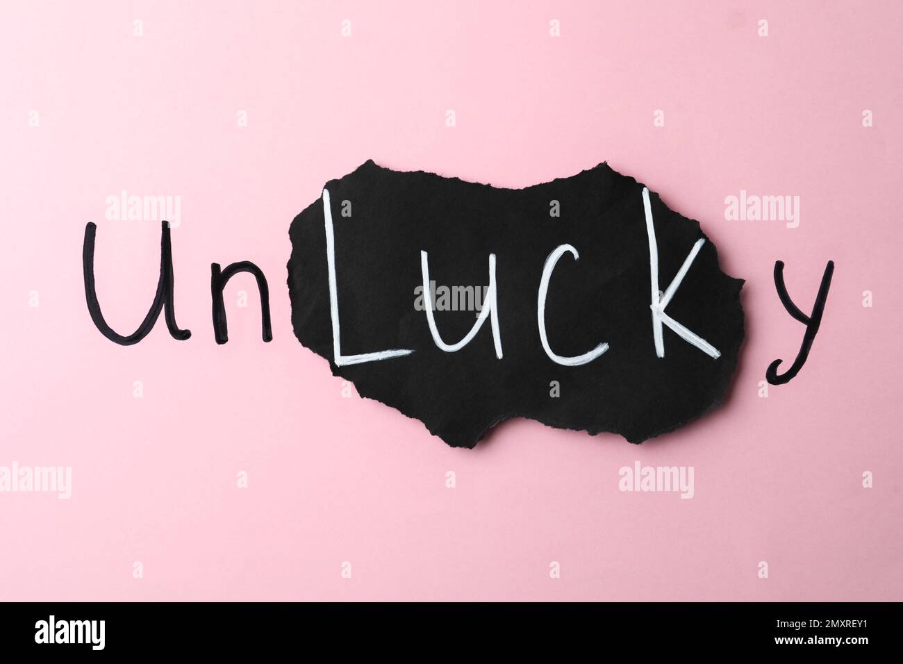 Word UNLUCKY on pink background, top view Stock Photo - Alamy