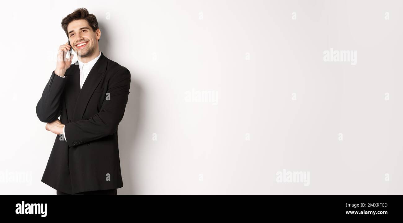 Image of handsome and successful businessman talking on phone, smiling ...