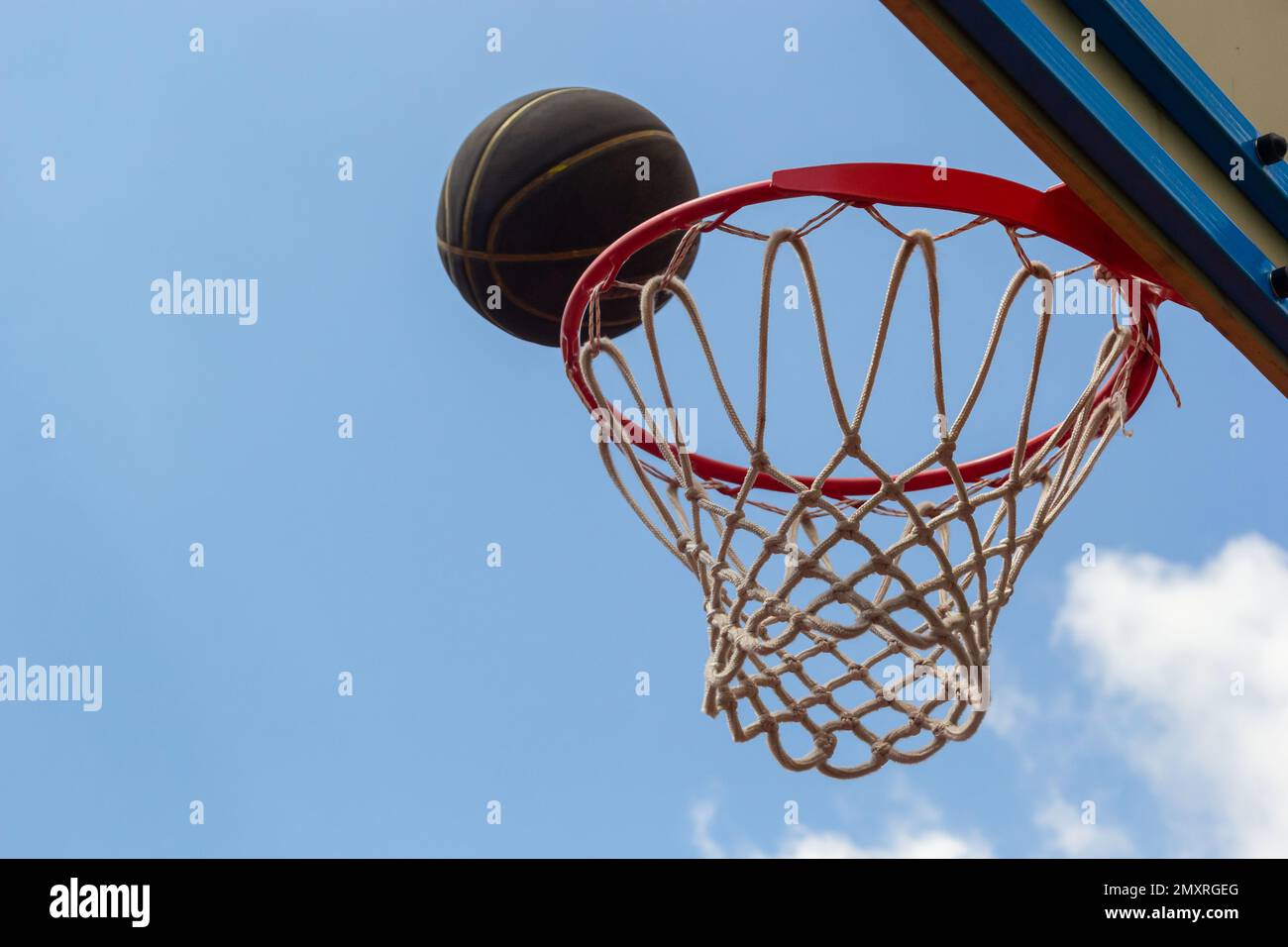 A basketball in the net. The fly ball is in the ring. A sports game ...