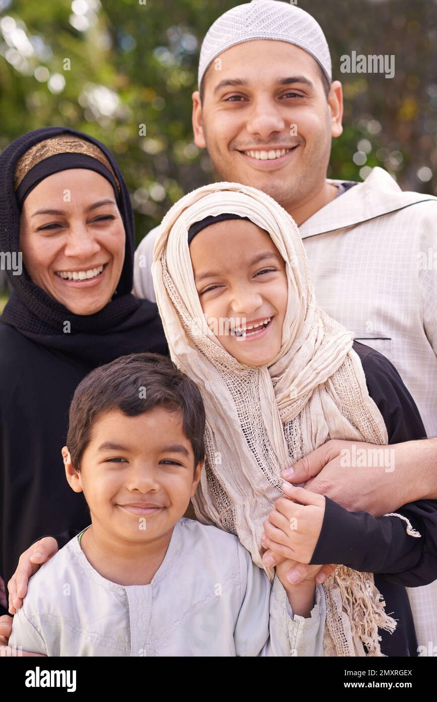 Laughing together. Portrait of a muslim family enjoying a day outside ...