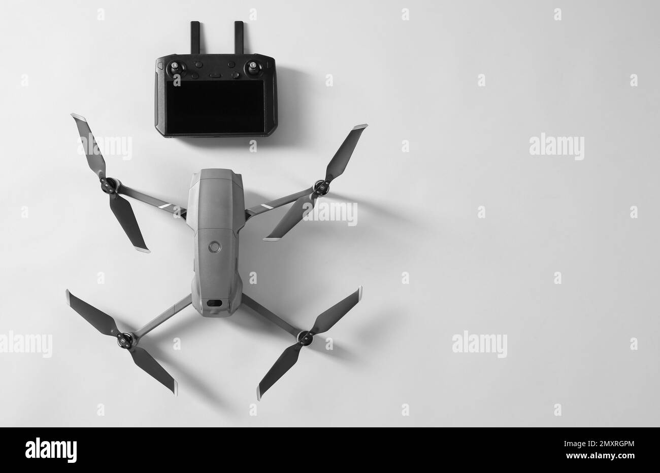 Modern drone with controller on light background, top view. Space for ...