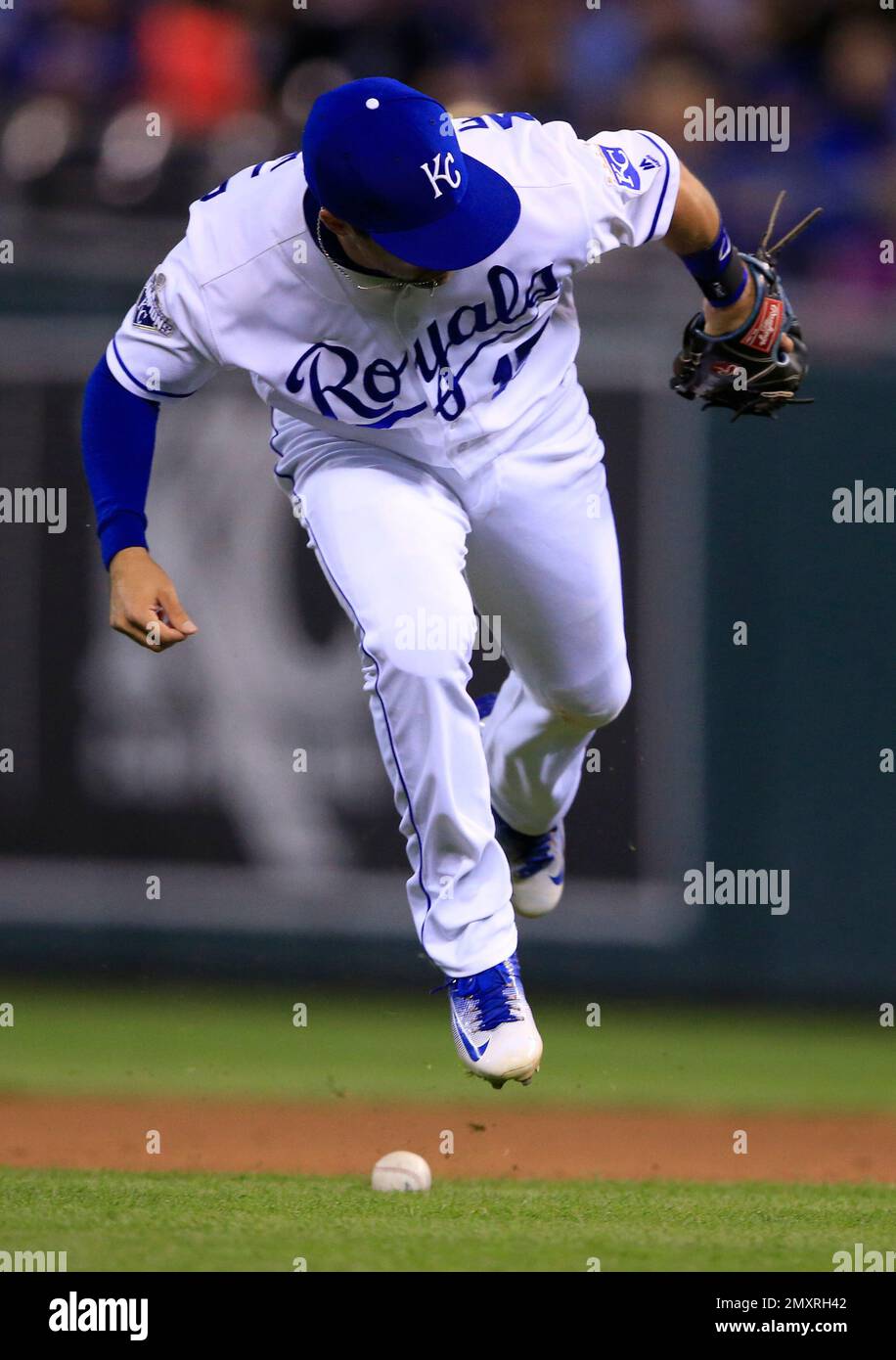 Kansas City Royals second baseman Whit Merrifield tries to barehand a ...