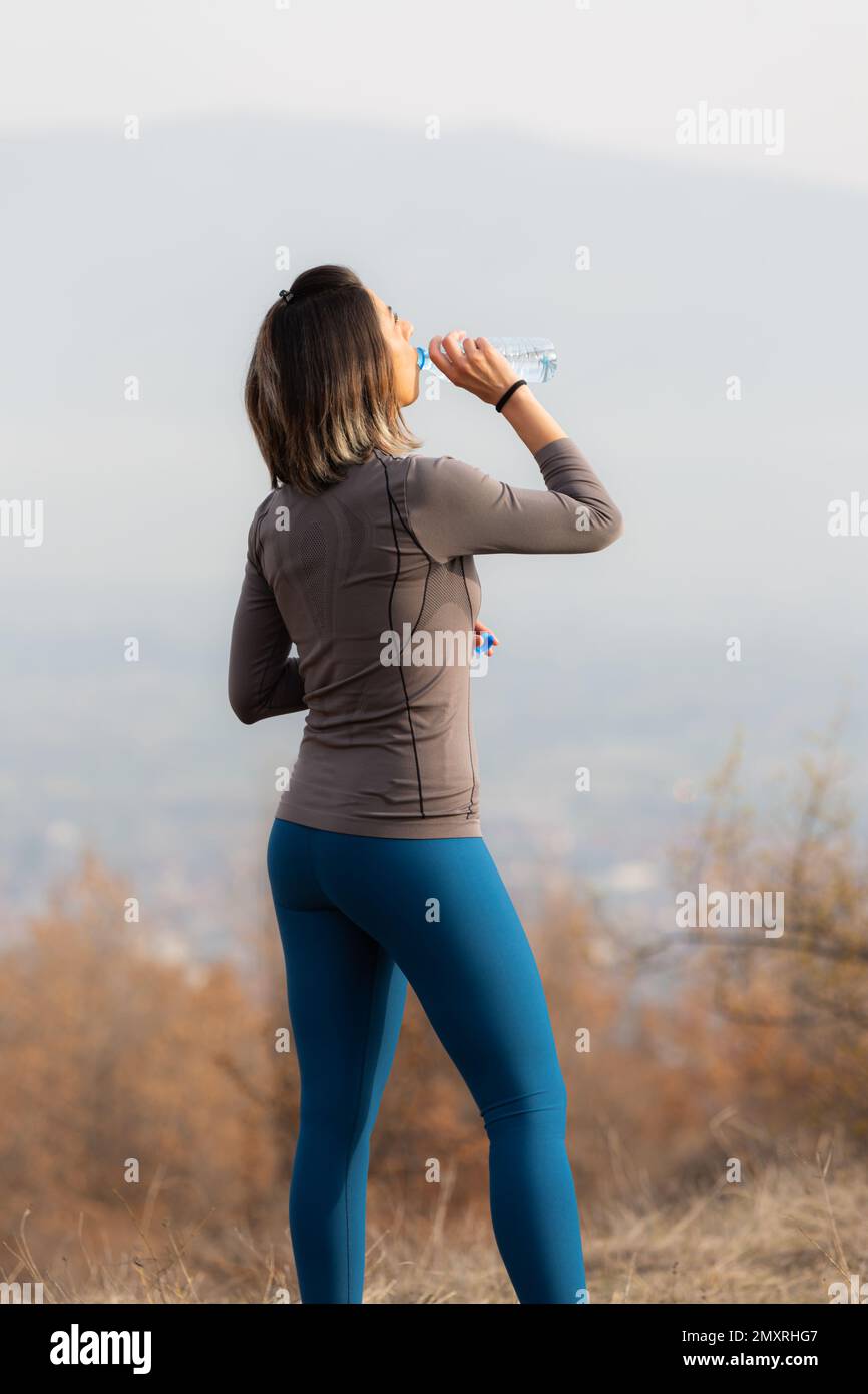 Amazing and active woman is drinking water Stock Photo - Alamy