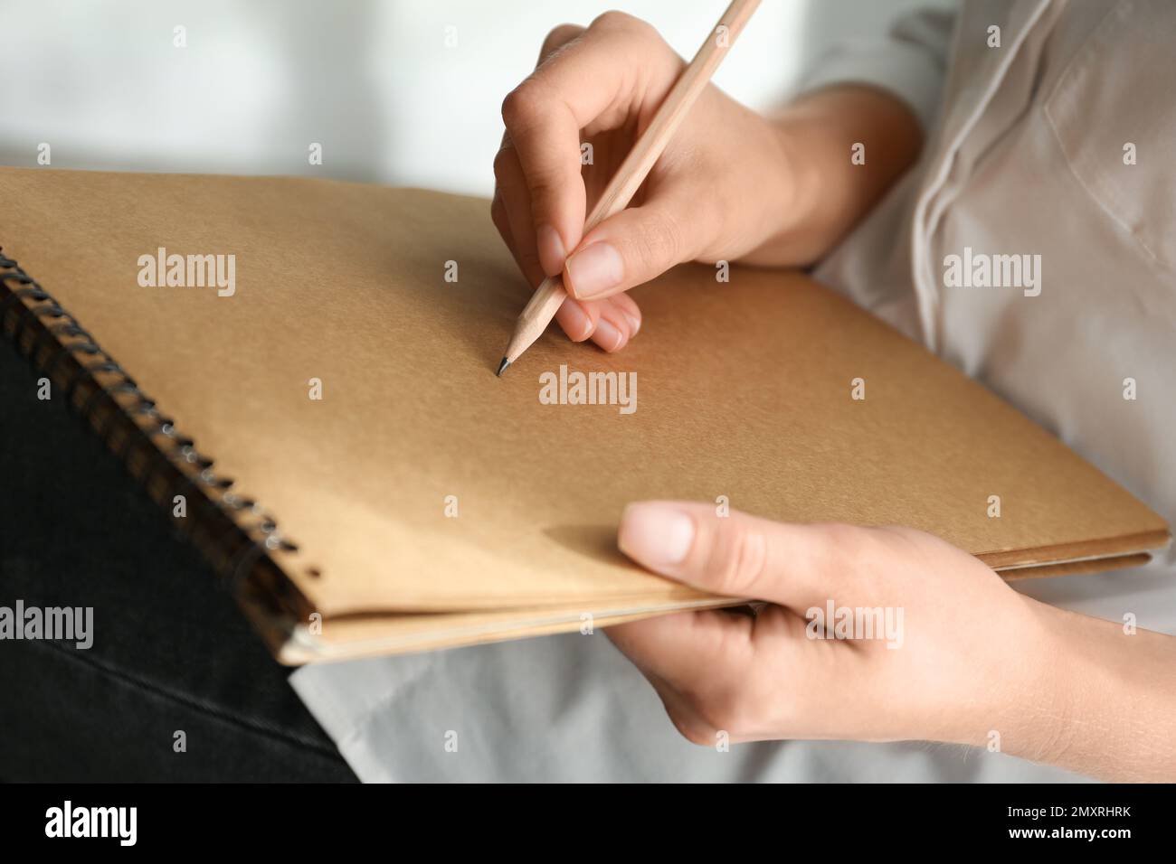 Woman drawing with pencil in notepad, closeup Stock Photo - Alamy
