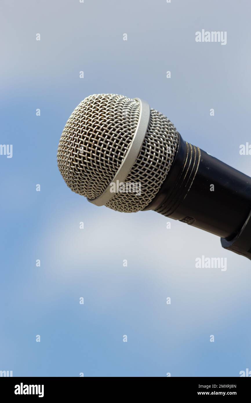 Microphone on sky background. The microphone is on the street. Concept ...