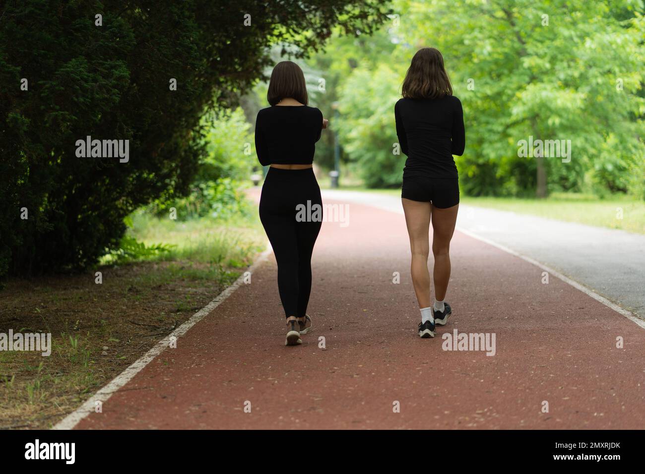 Two attractive and beautiful young girls are taking rek from running ...