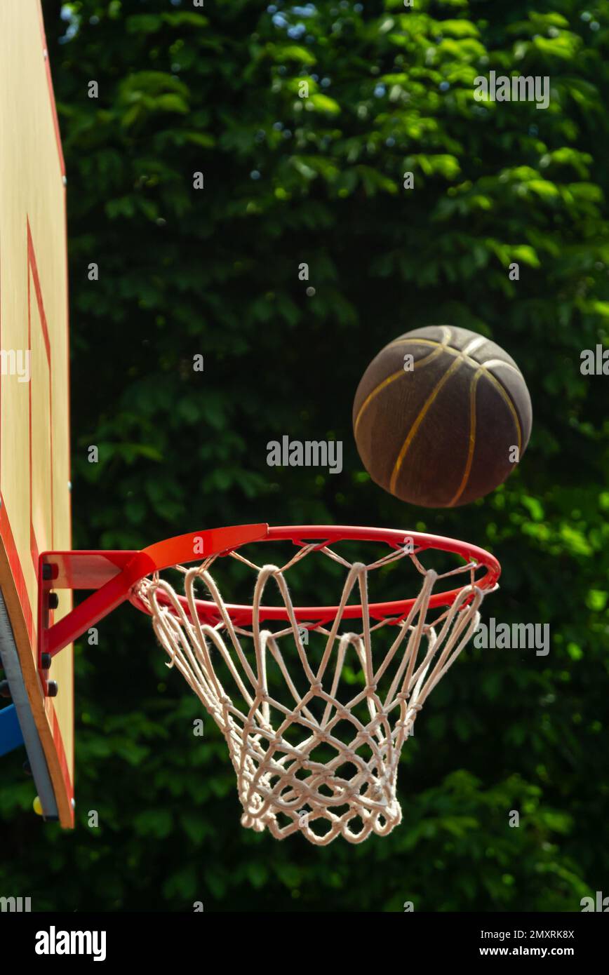 A basketball in the net. The fly ball is in the ring. A sports game ...