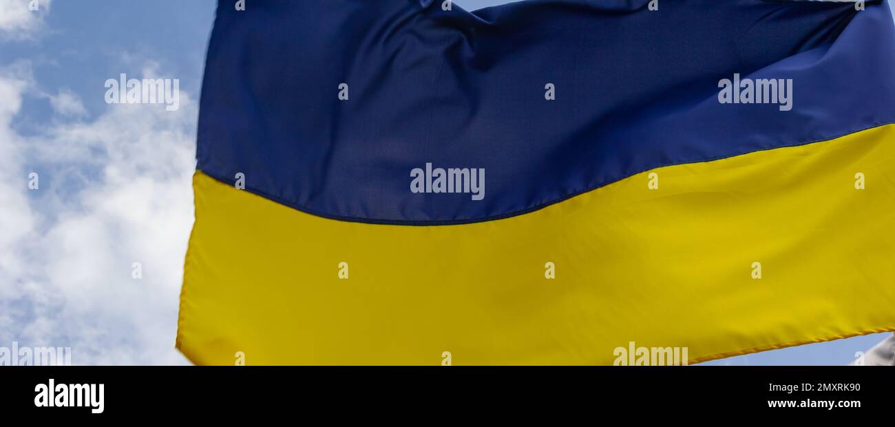 Ukraine flag isolated on the blue sky with clipping path. close up ...