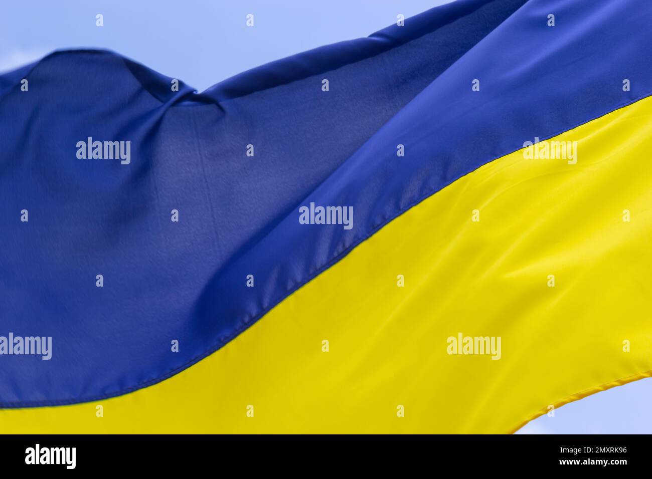 Ukraine flag isolated on the blue sky with clipping path. close up ...