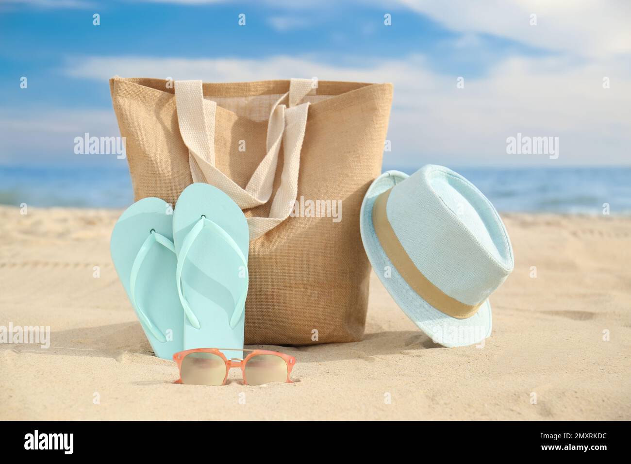 Different stylish beach objects on sand near sea Stock Photo - Alamy