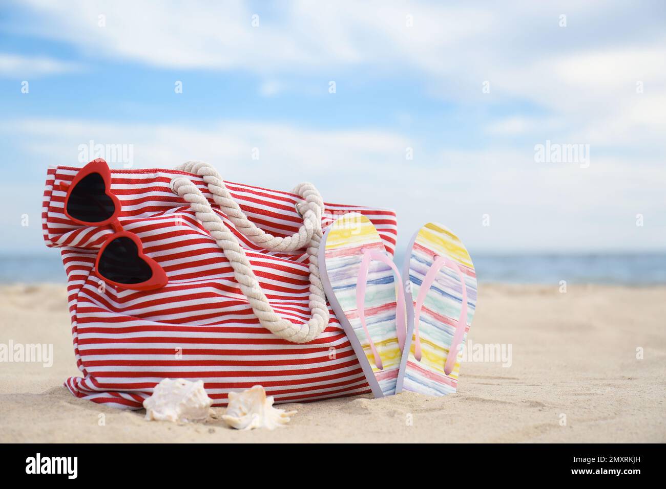 Different stylish beach objects and seashells on sand near sea Stock ...