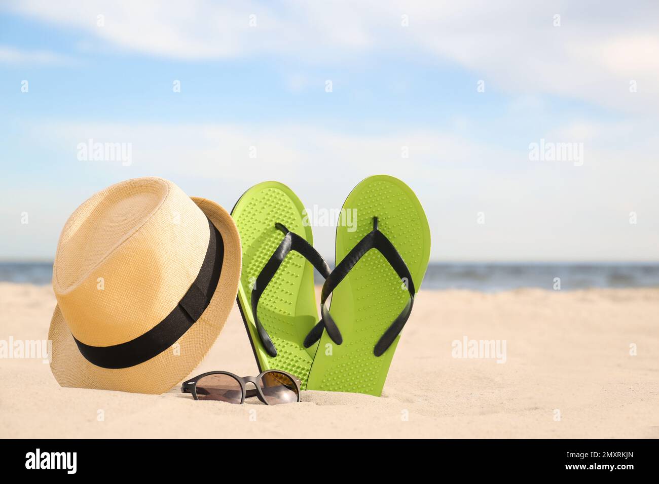 Different stylish beach objects on sand near sea Stock Photo - Alamy