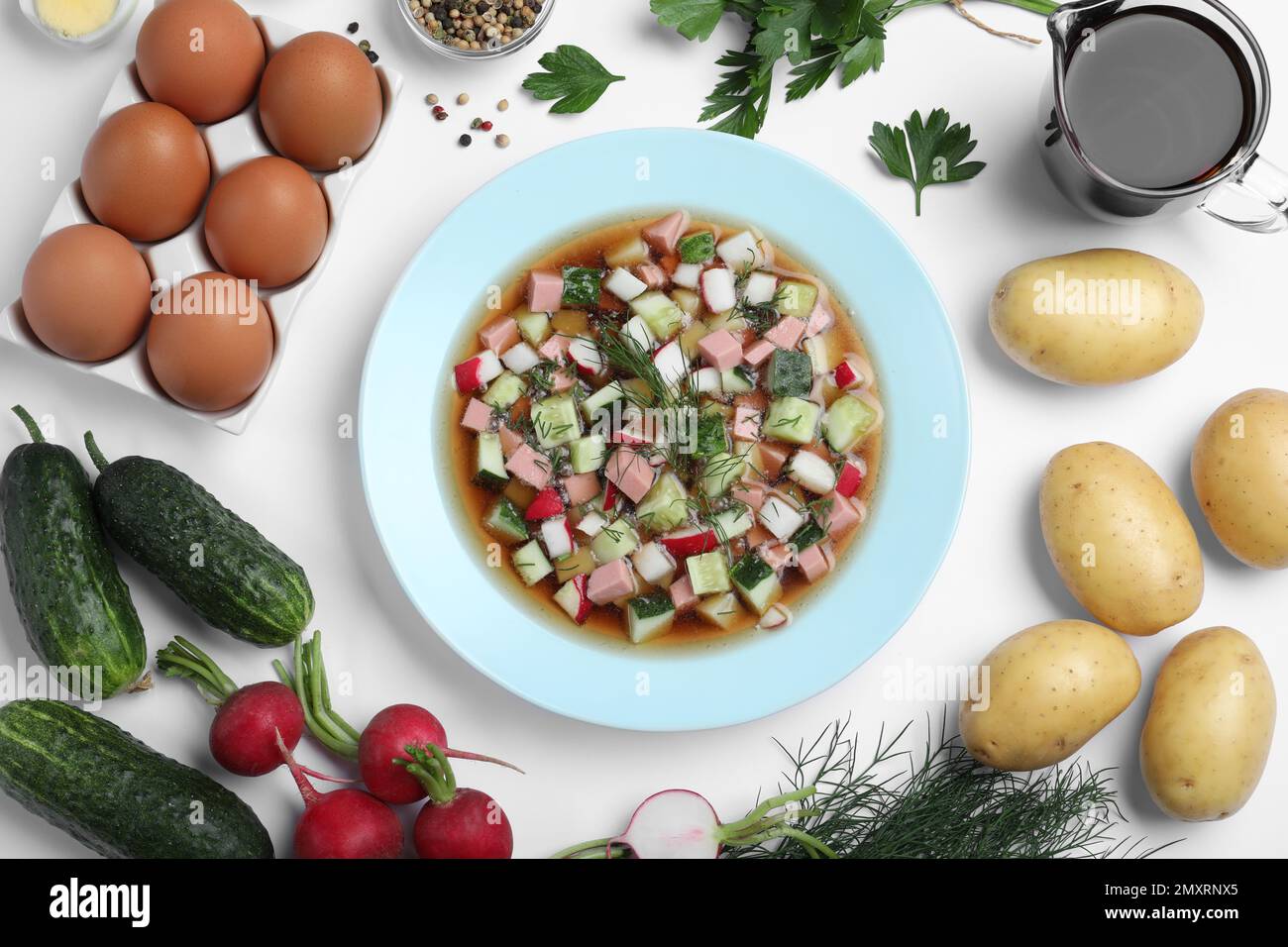Cold okroshka with kvass and ingredients on white background, top view ...