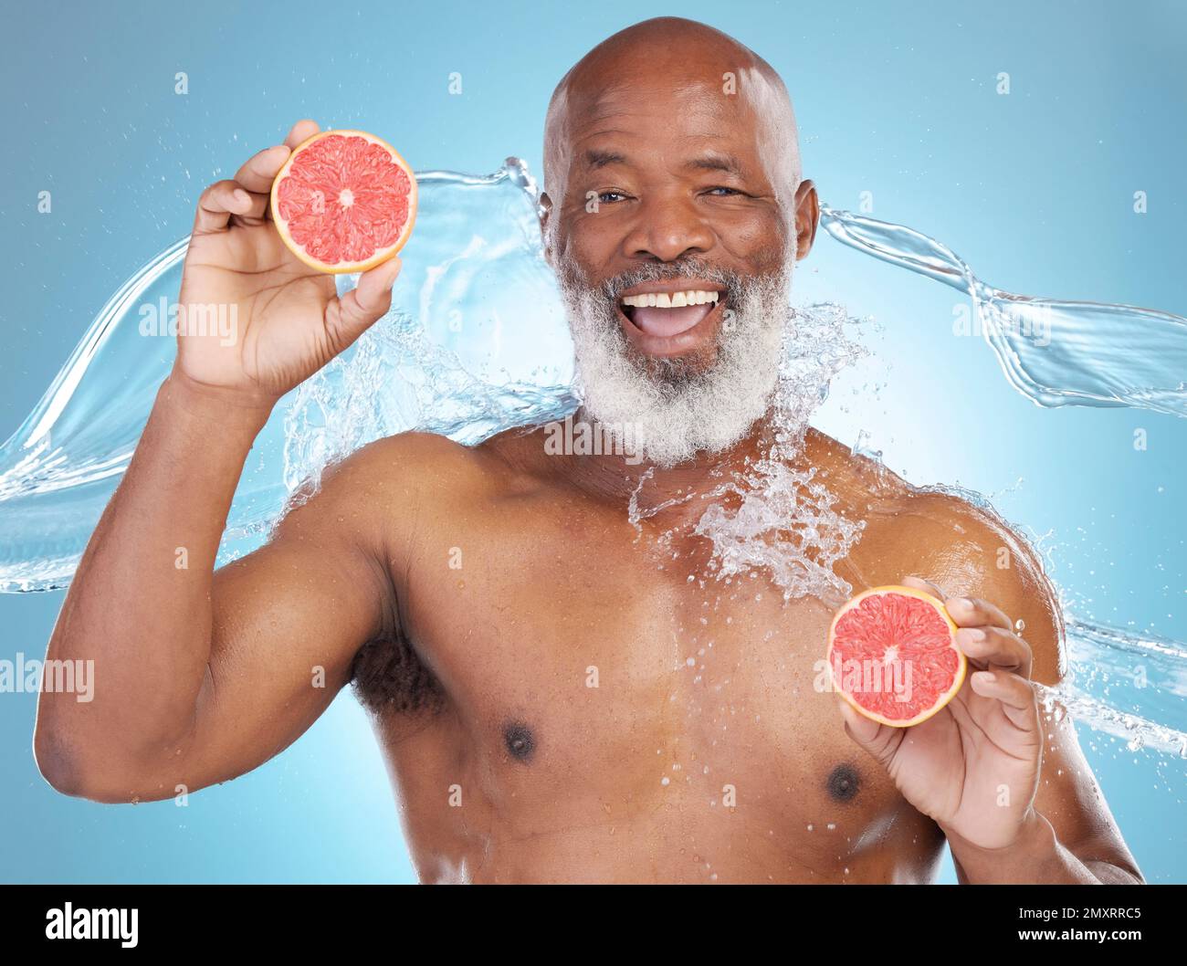 Black man, portrait smile and grapefruit for skincare nutrition, vitamin C or hydration against ...