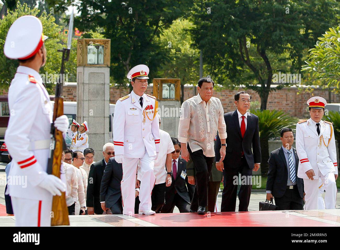 Philippines President Rodrigo Duterte, center, attends a wreath laying ...