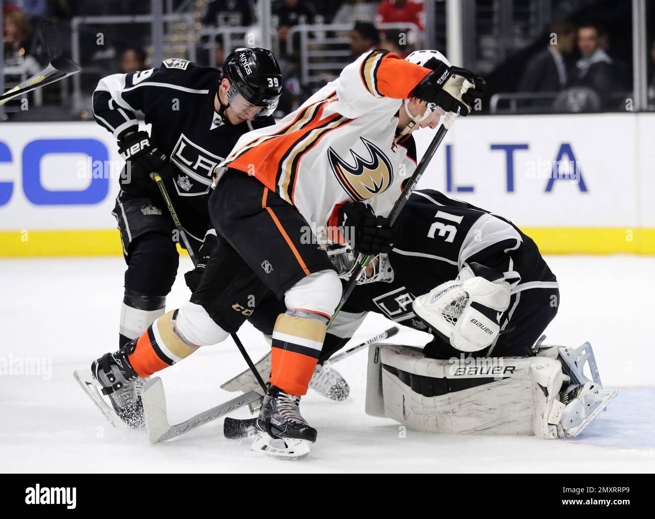 Los Angeles Kings goalie Peter Budaj, right, stops a shot by Anaheim ...
