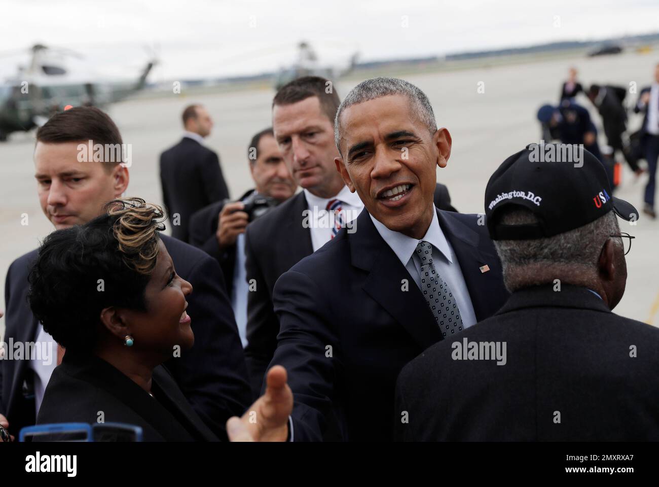 President Barack Obama greets people on the tarmac as he arrives on Air ...