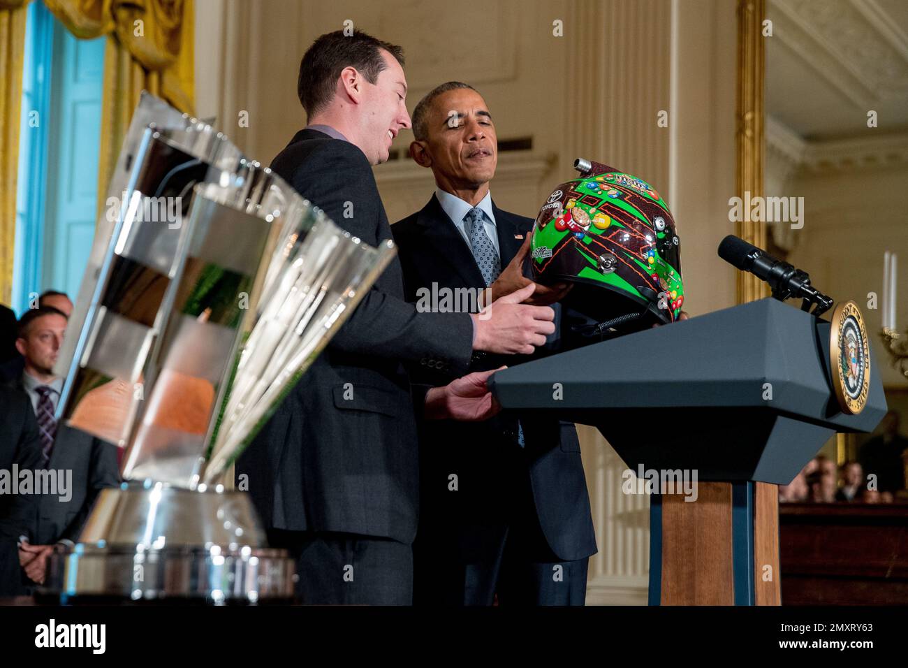 President Barack Obama stands with NASCAR race car driver Kyle Busch as ...