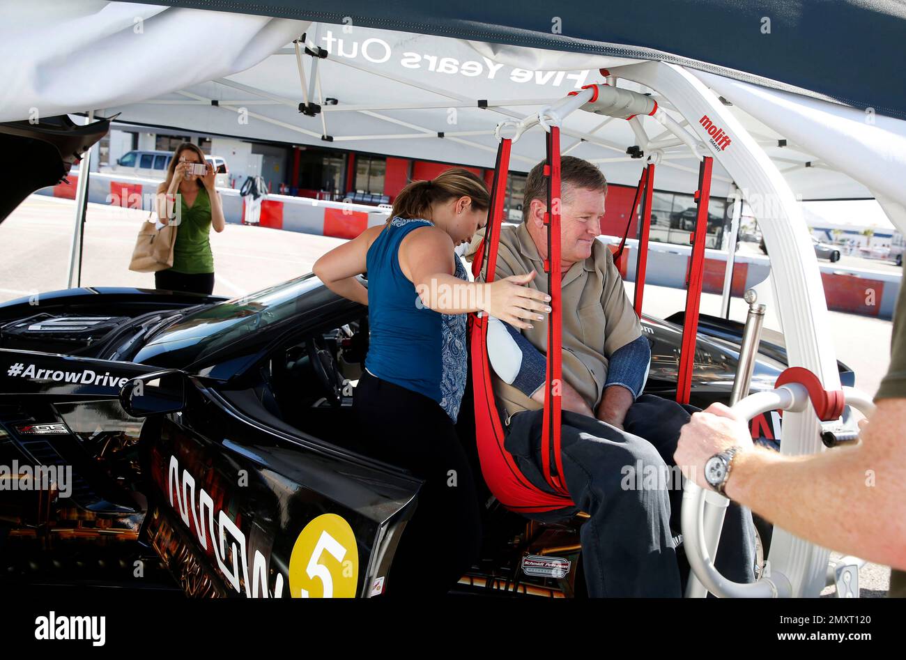 Indy Racing League driver Sam Schmidt exits his modified Corvette on ...