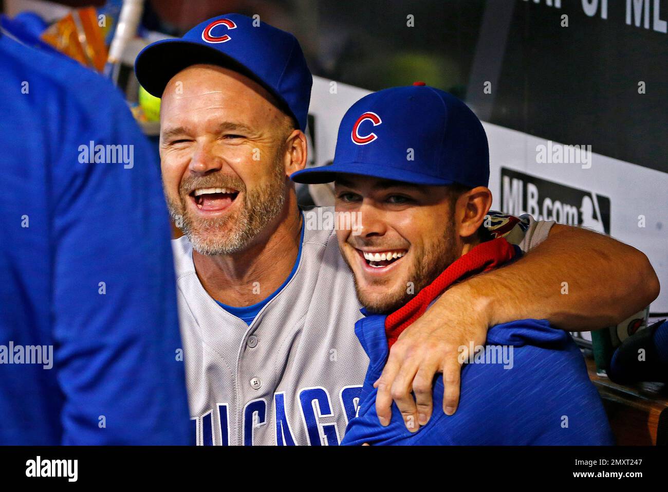 Chicago Cubs' David Ross, left, hugs teammate Kris Bryant on the bench ...