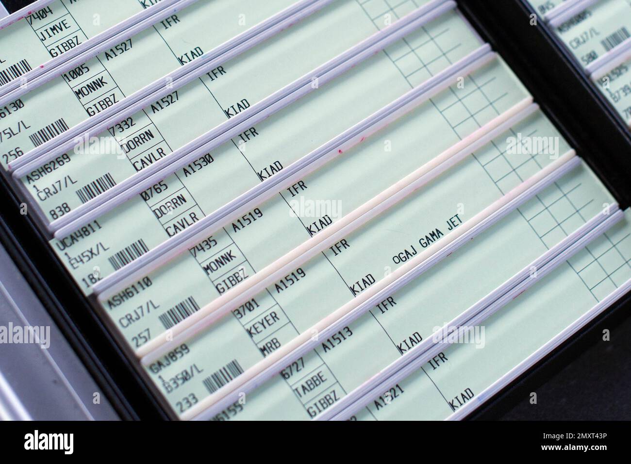 Active FAA flight progress strips are seen in the Dulles International ...